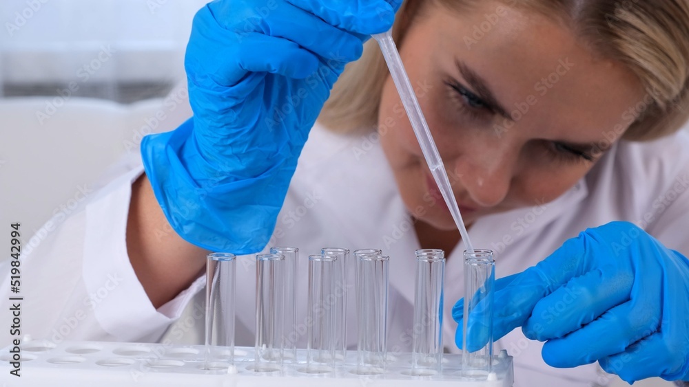 professional scientist laboratory assistant takes and examines samples ...