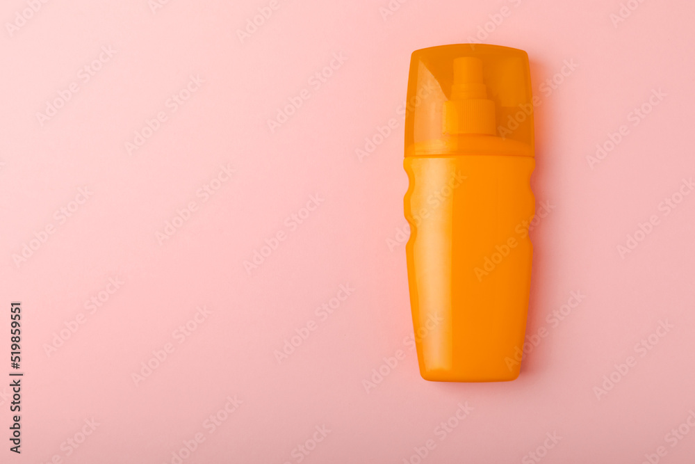 Sunscreen on a pink background. Plastic bottle of SPF sunscreen ...