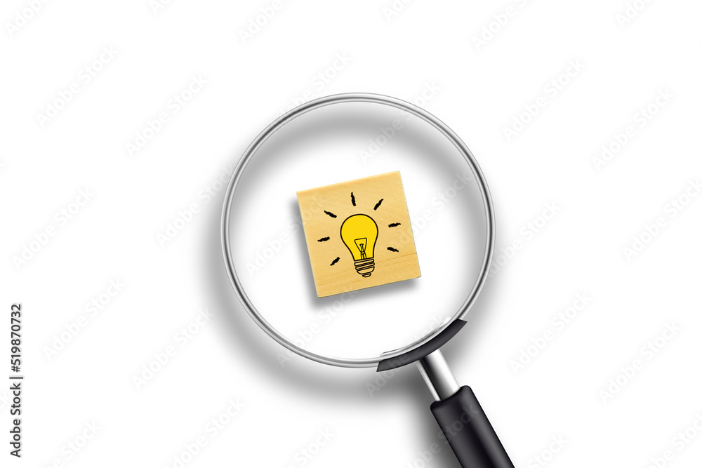 Creative idea concept, magnifying glass and light bulb icon on wooden ...