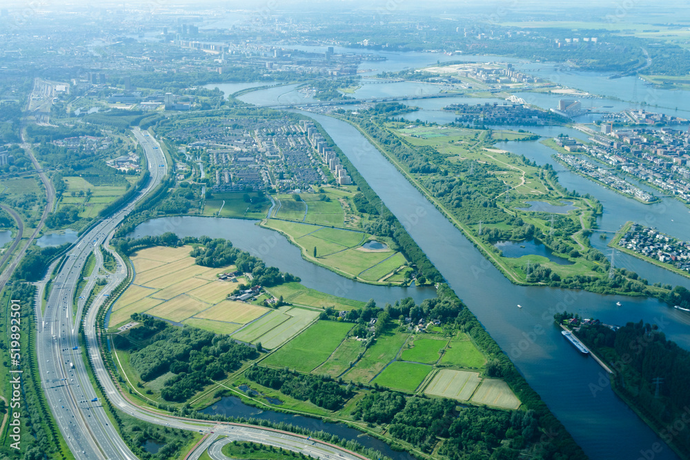 Aerial view of marshlands, modern city and river from airplane Stock ...