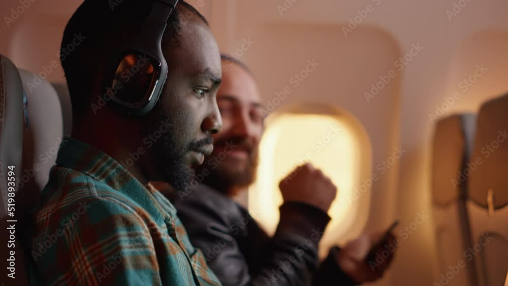 Male passenger working on laptop and travelling by plane, flying in ...