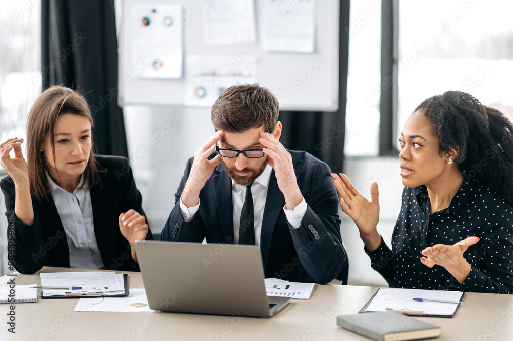Annoyed business employees of different nationalities, work at the ...