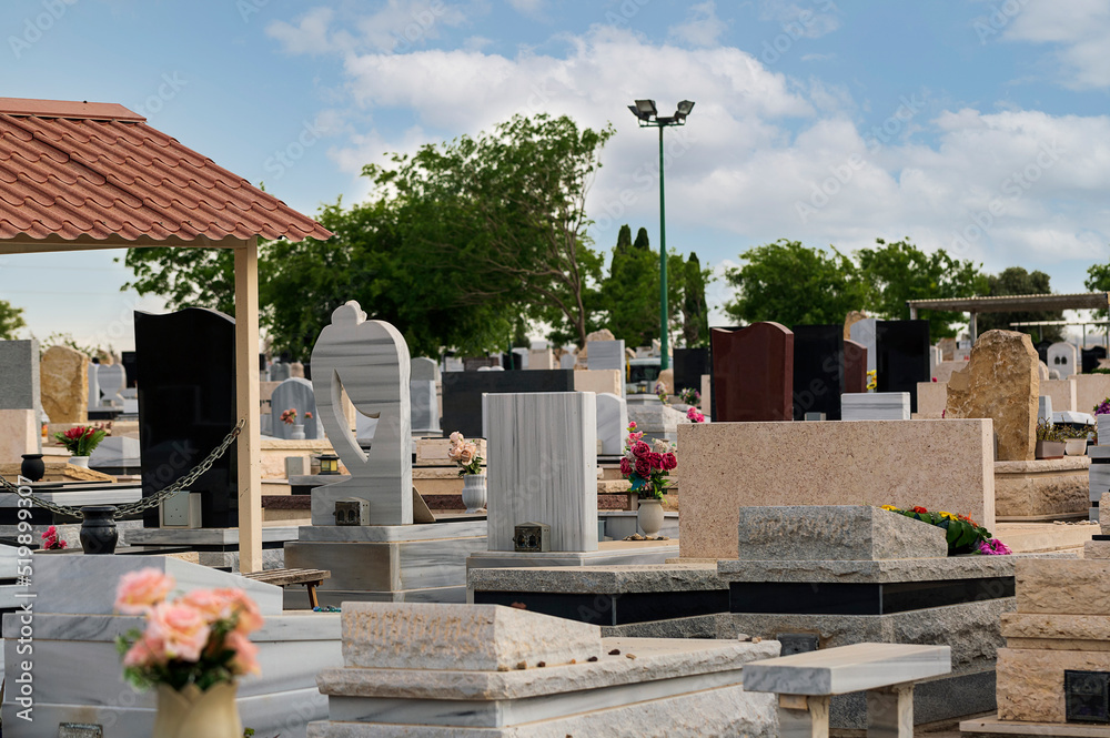 Modern gravestones at a public Jewish cemetery in Israel on a sunny day ...