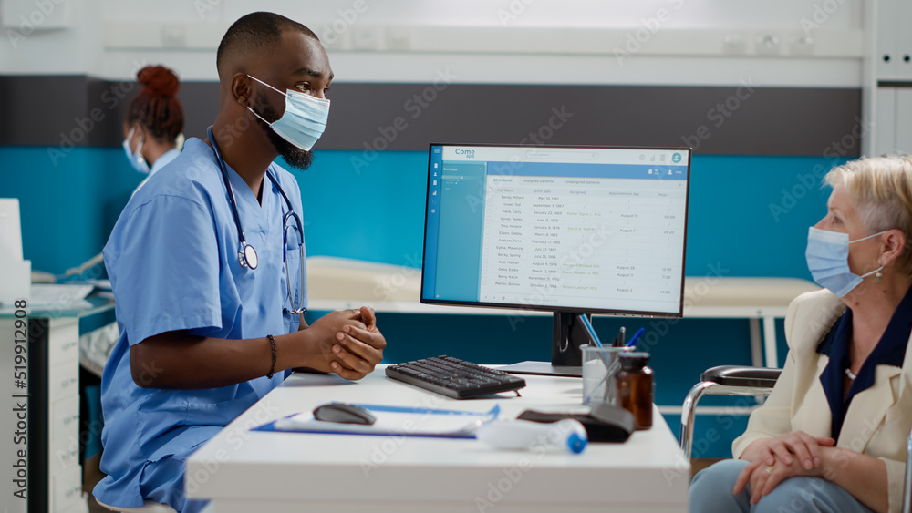 Medical worker talking to woman wheelchair user about disease, dealing ...