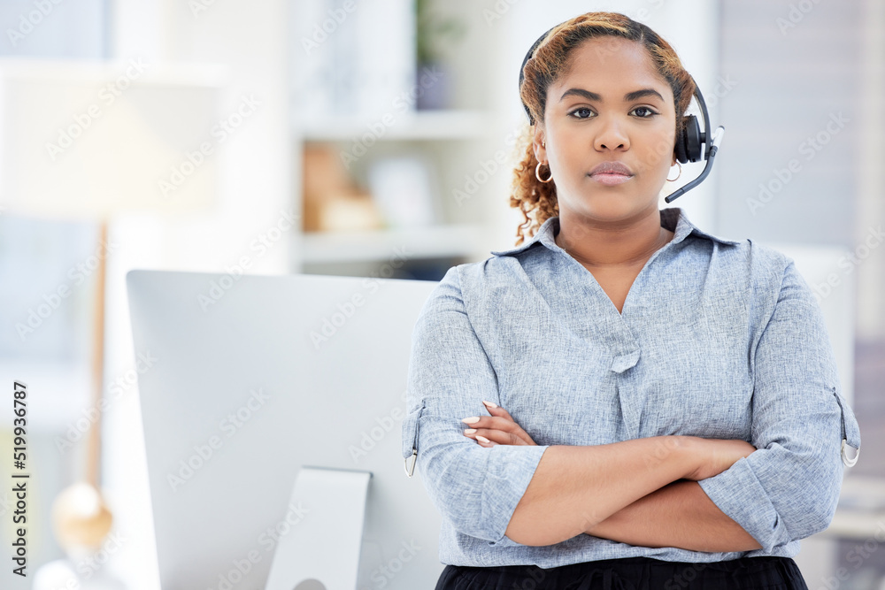 Serious female customer service worker with headphones at the office at ...