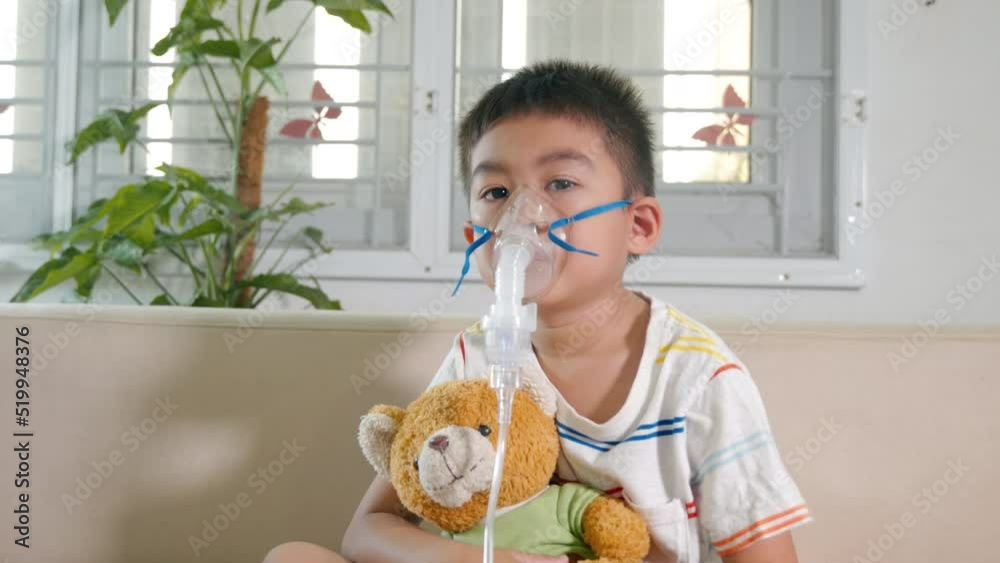 Asian Child using nebulizer mask equipment alone have smoke, Kid boy ...