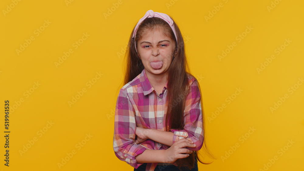 Cheerful funny young preteen child girl kid showing tongue making faces at camera, fooling ...