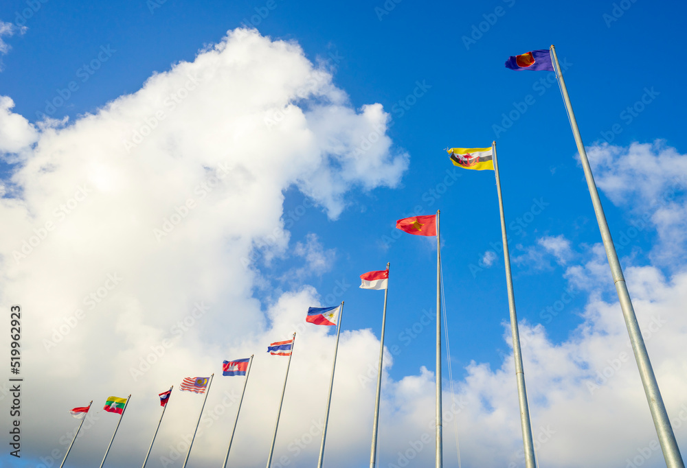 ASEAN flags and the member nations flags on blue sky and white cloud ...
