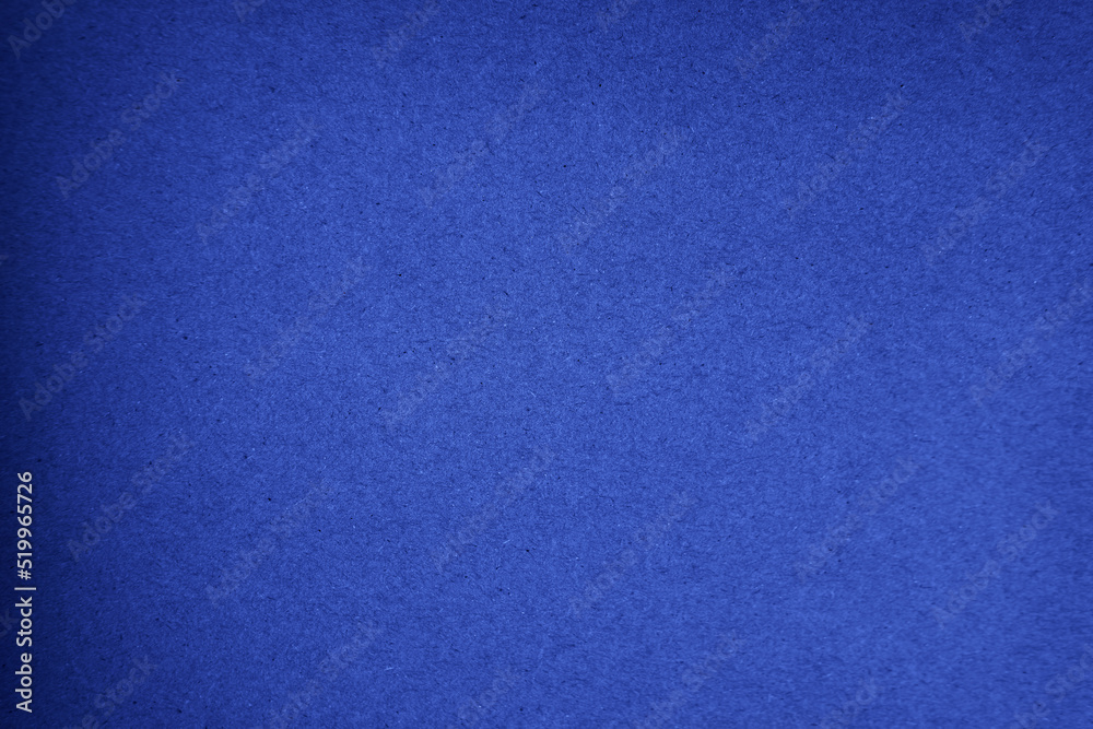 Colorful vibrant navy blue tone color on sandy recycled cardboard box ...