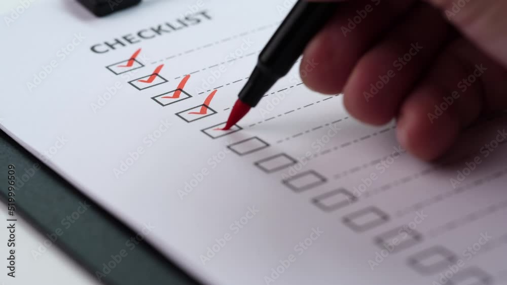 Checklist and To Do List Concept. Close-up businessman tick off or ...