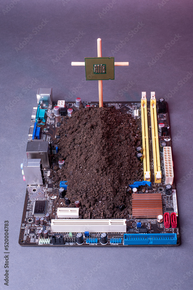 the computer board is covered with earth. pc chip shortage concept ...
