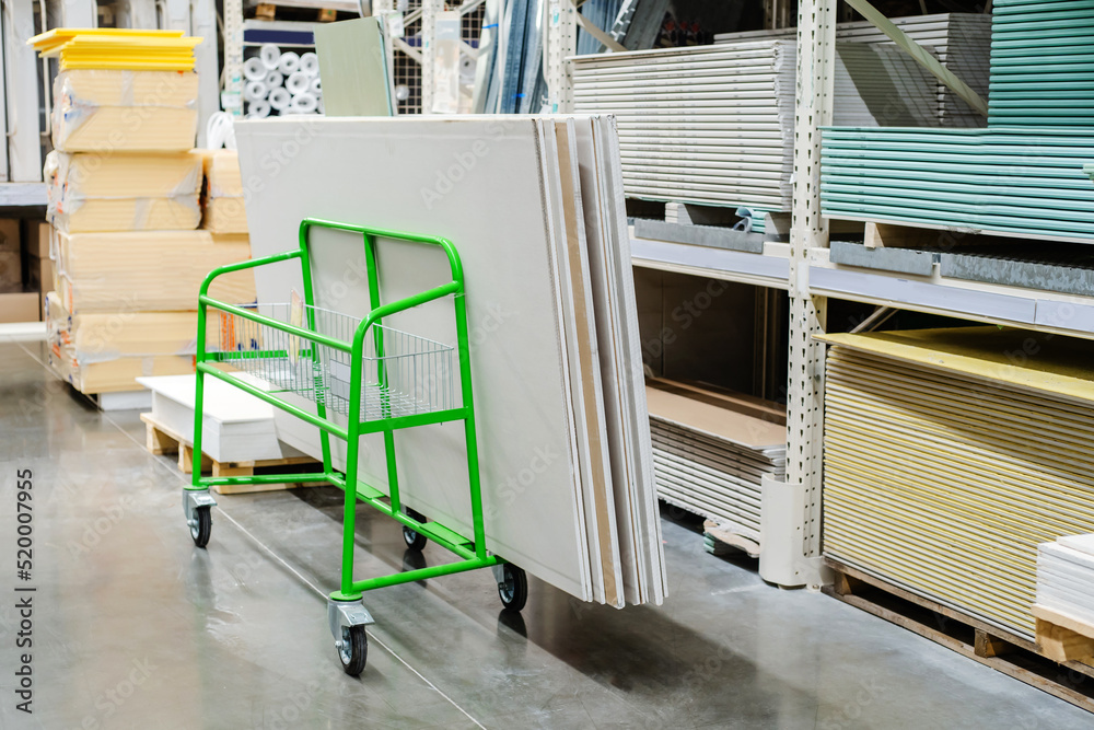 Drywall on a transport trolley in a building materials store. Trade in ...