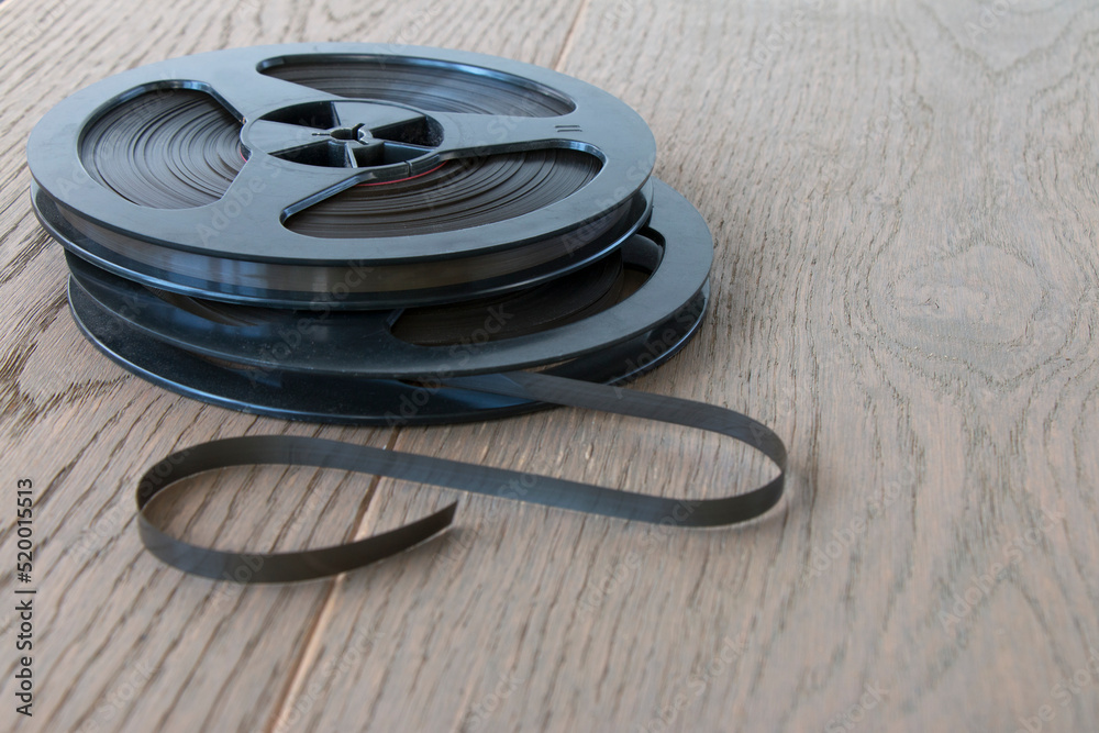 reels of magnetic tape from a vintage audio tape recorder, close-up ...