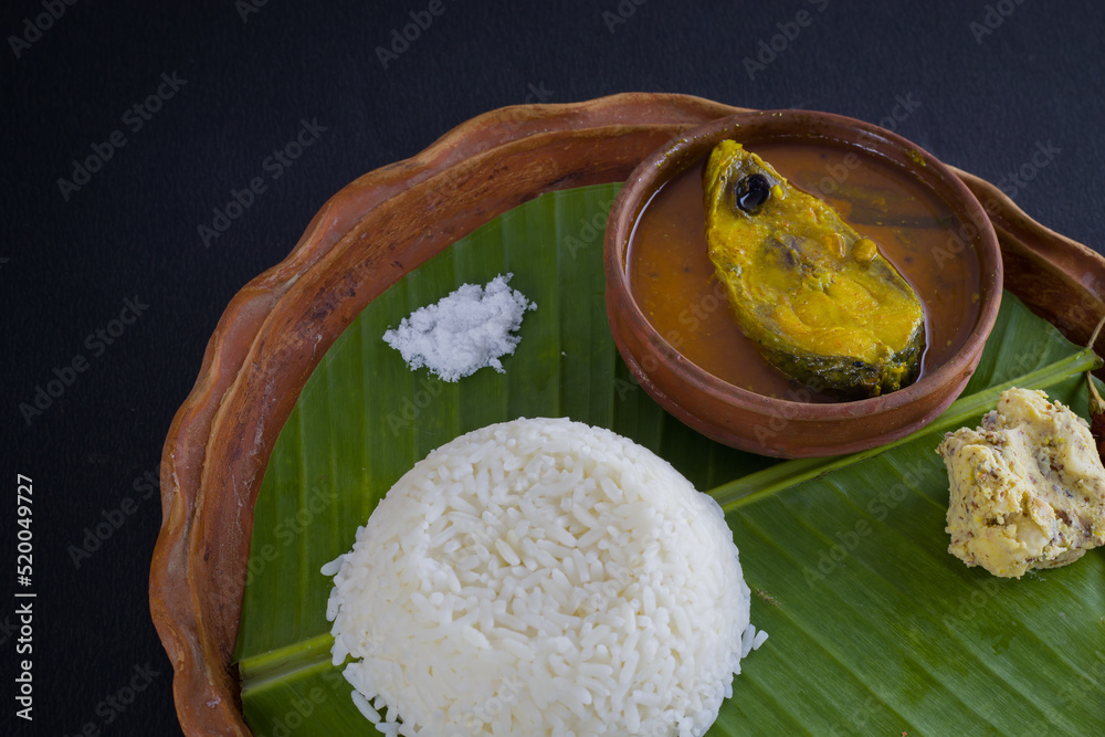 Hilsa or ilish fish and rice served as traditional Bengali Indian lunch ...