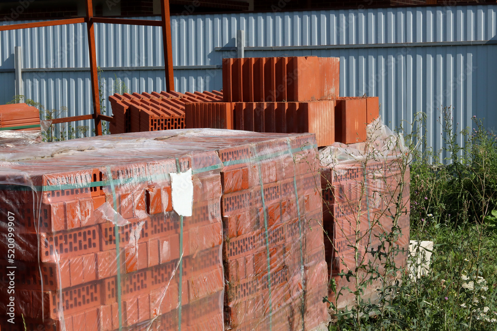 Red ceramic bricks in packaging at a construction site. Keramoblock ...