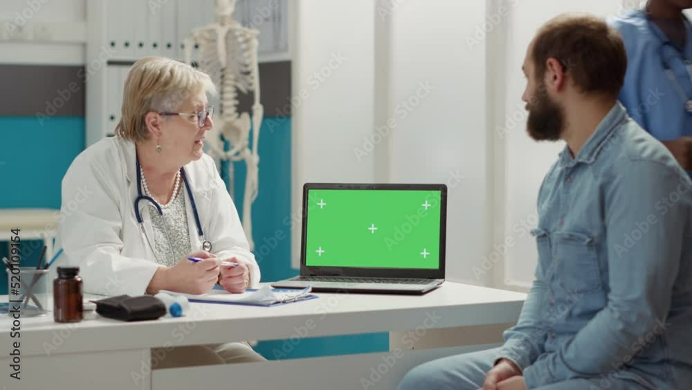 Physician and patient analyzing greenscreen template on laptop, using ...