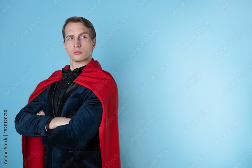 superhero stands in a heroic pose, a man in a business suit and a red ...