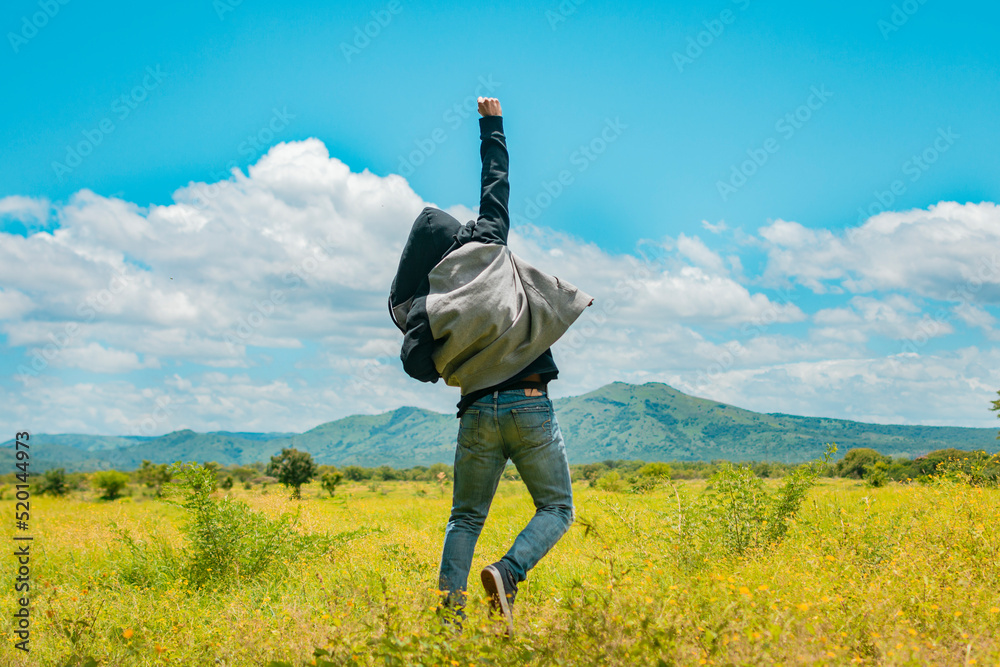 Man from back jumping in a nice field, Rear view of man jumping in the ...