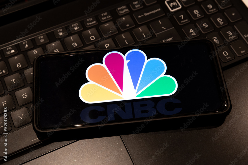 CNBC logo on smart phone screen , , background is a keyboard July 30 ...