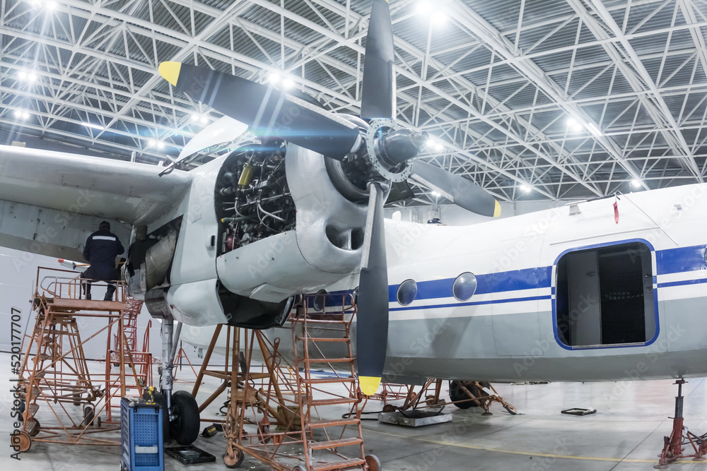 Transport turboprop airplane in the hangar. Close-up of an open ...