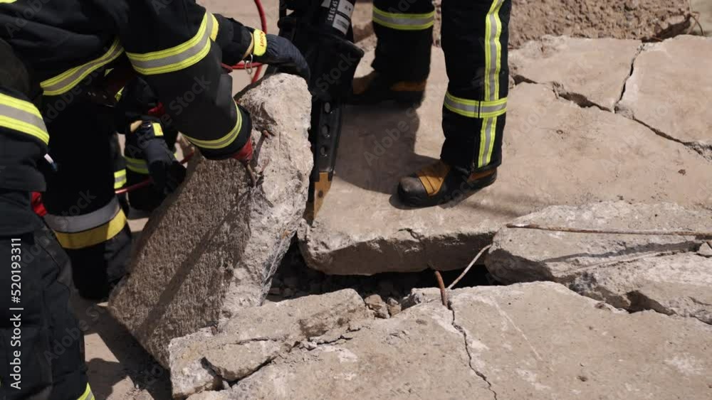 As a firefighter, a man in a uniform performs a rescue, with a power ...
