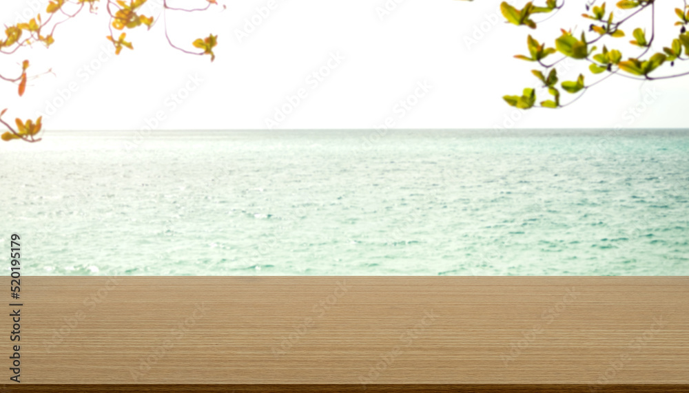 Wood table on blue sea and green leave with bue sky background.montage ...