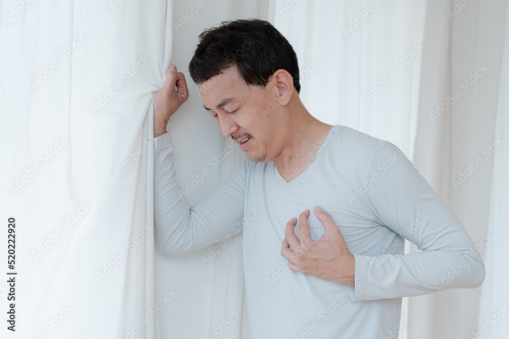 a man touching his heart, with red highlight of heart attack, and ...