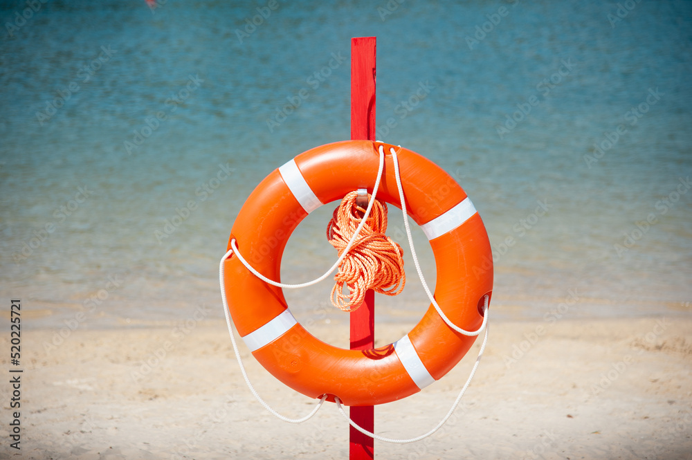 Life preserver on sandy beach a sea background/beach season. Lifebuoy ...