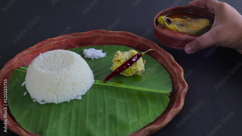 4k video of Hilsa or ilish fish curry and rice served as traditional ...