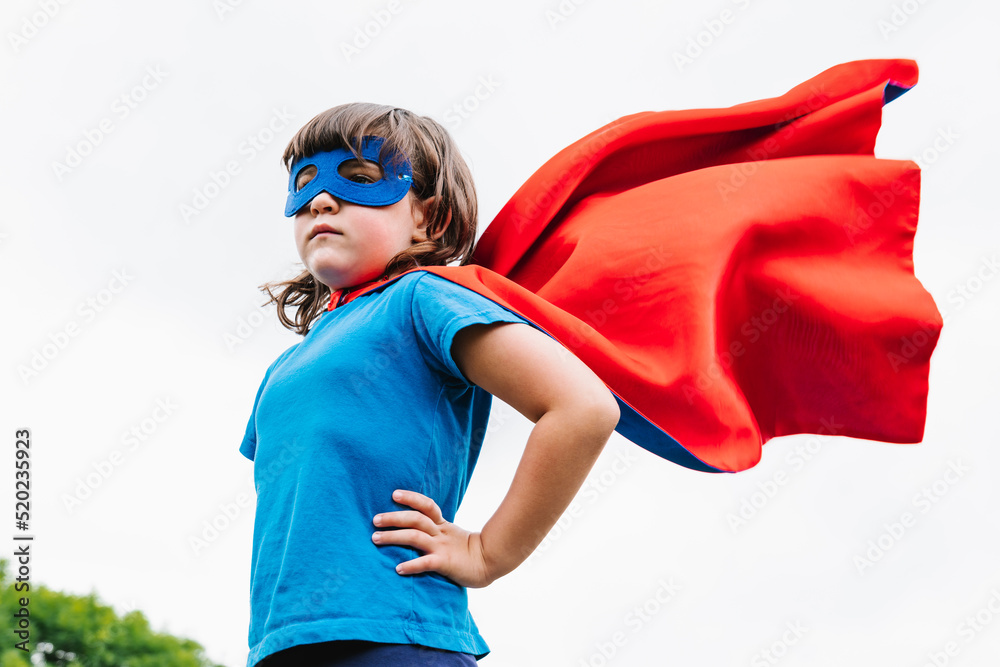 Little superhero with flying cape Stock Photo | Adobe Stock