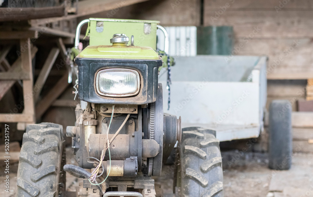Typical heavy diesel walking tractor with trailer. Agricultural ...