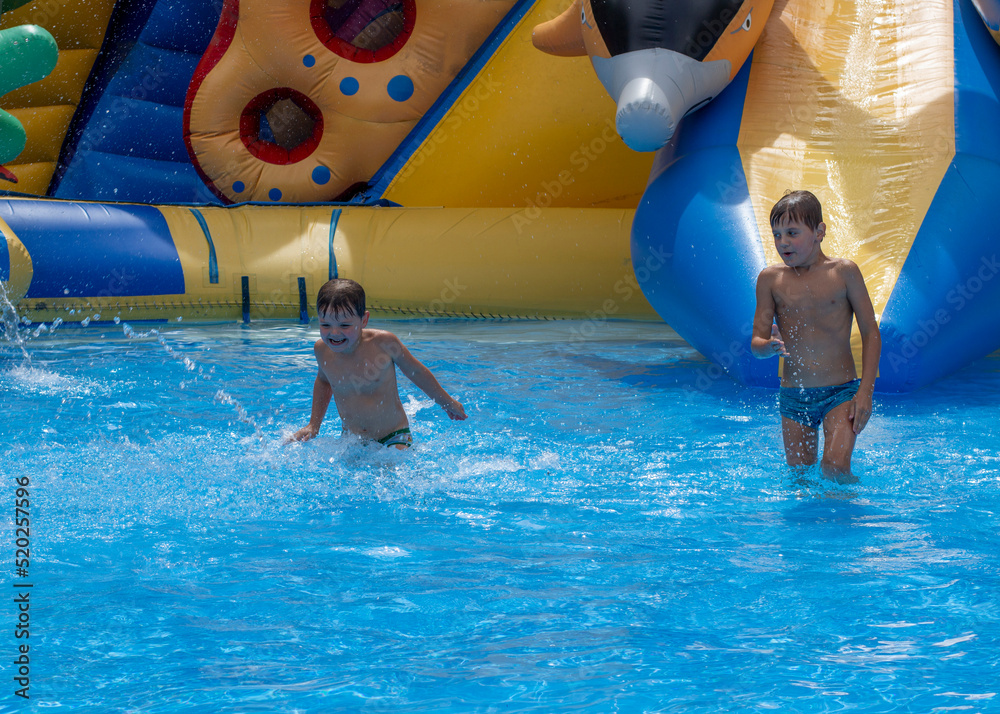 Children play and swim in pool. Two children are having fun in pool ...