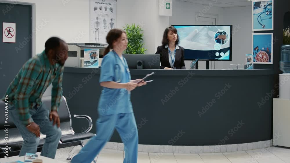 Busy hospital reception desk with many patients waiting to start ...