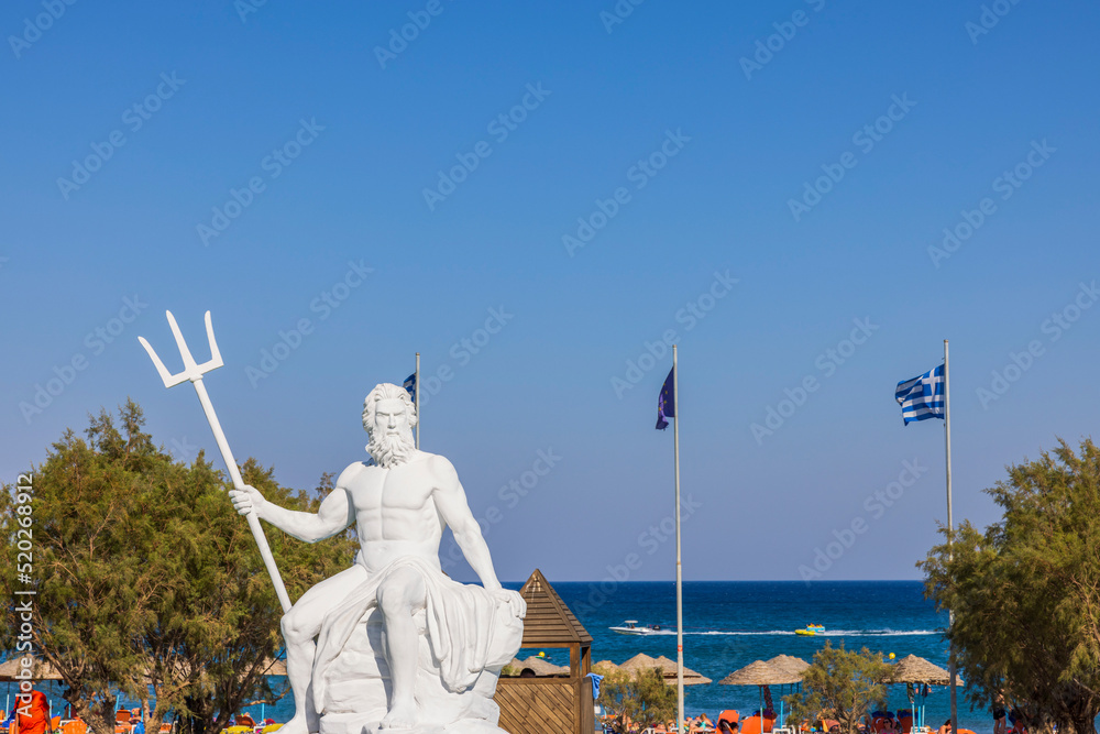 Beautiful view of Poseidon sculpture on Greek flags and blue sky ...