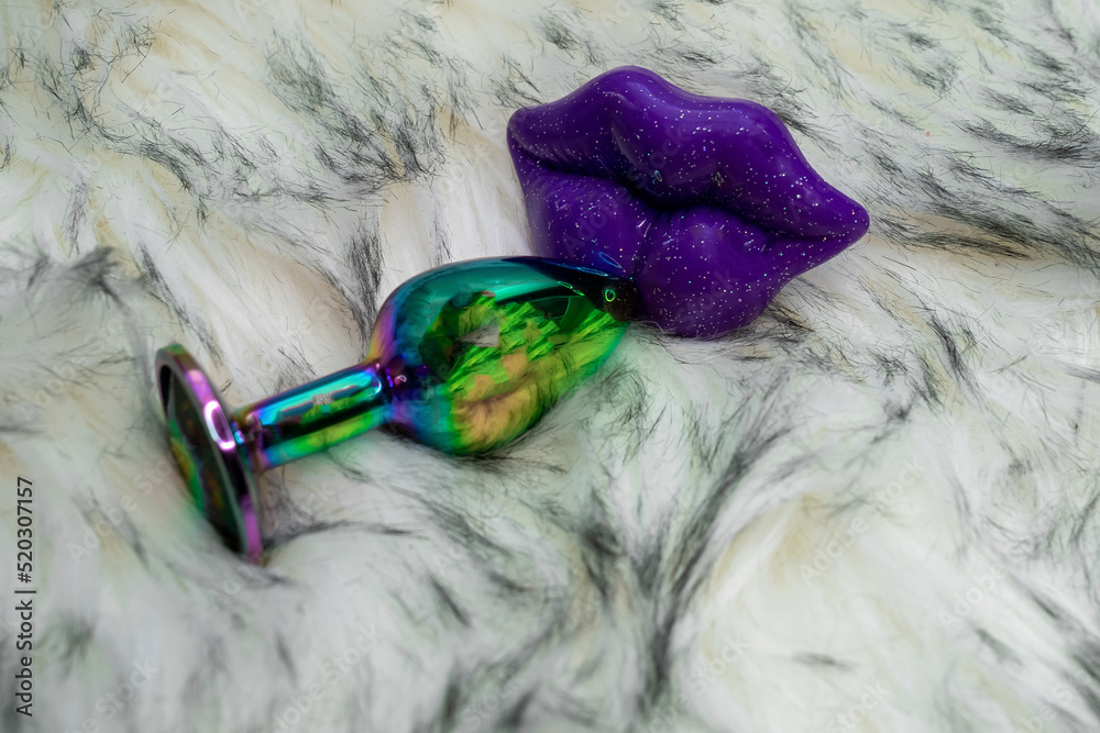 sexy butt ass plug on the gray background, next to lips on the bed Stock 写真 | Adobe Stock