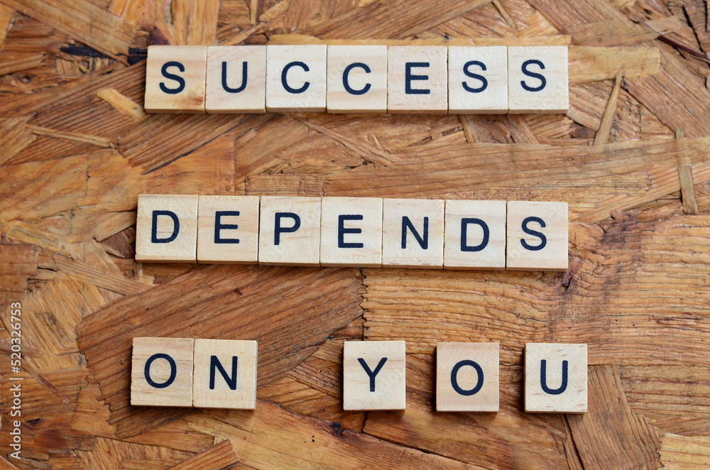 success depends on you text on wooden square, motivation and business ...