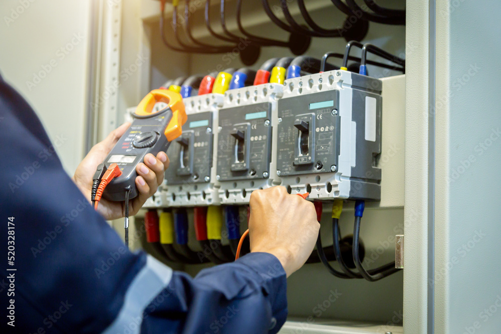 Electrical engineer using measuring equipment to checking electric ...