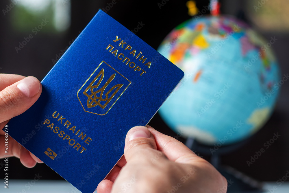 Ukraine, passporton the background of the globe. Ukrainian passports in ...