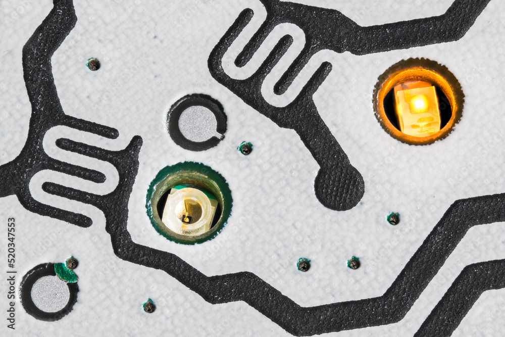 Lit and non-lit LED diode in small holes of PCB detail from dismantled ...