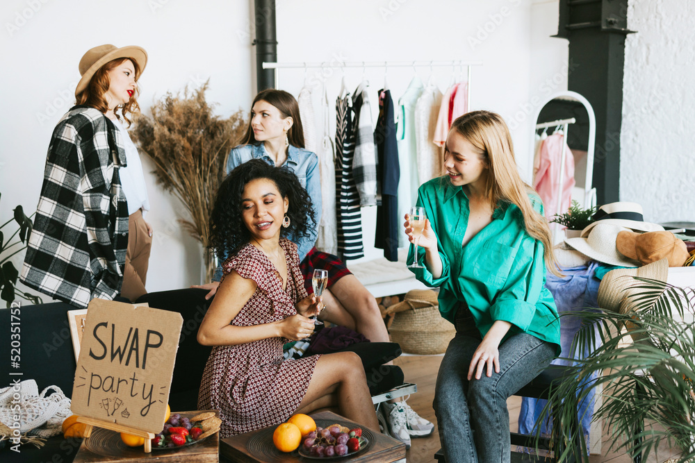 four young woman female caucasian and african students at swap party ...
