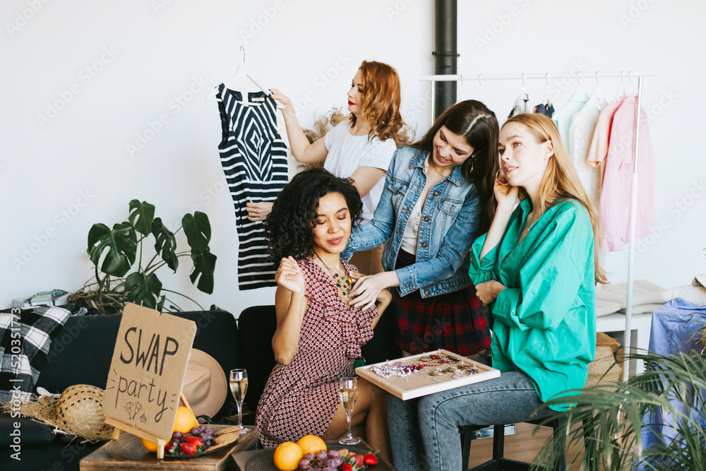 four young woman female caucasian and african students at swap party ...