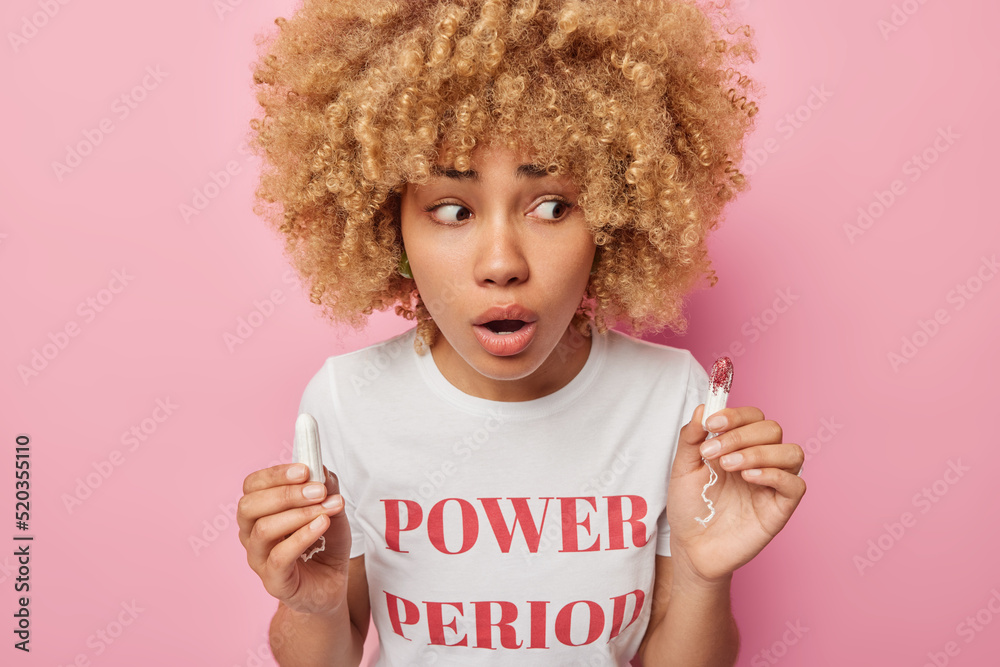Menstruation and hygiene concept. Surprised curly haired young European ...