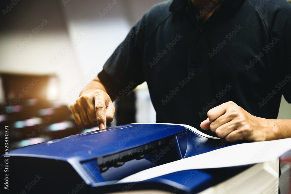 Technician hand press button and load paper in tray to using ...