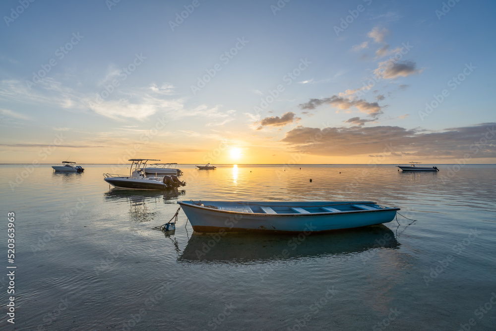 Tranquil sunset at the beach with small fishing boats Stock Photo ...