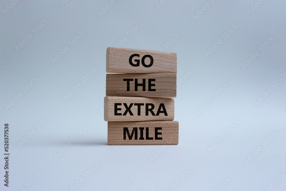Go the extra mile symbol. Wooden blocks with words Go the extra mile ...