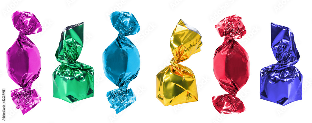 A set or collection of sweets in multi-colored foil packaging on an ...