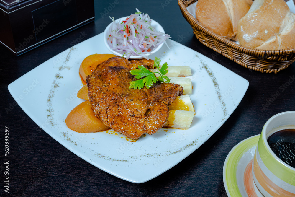 Peruvian food "Frito de chancho" traditional dish made with fried pork ...