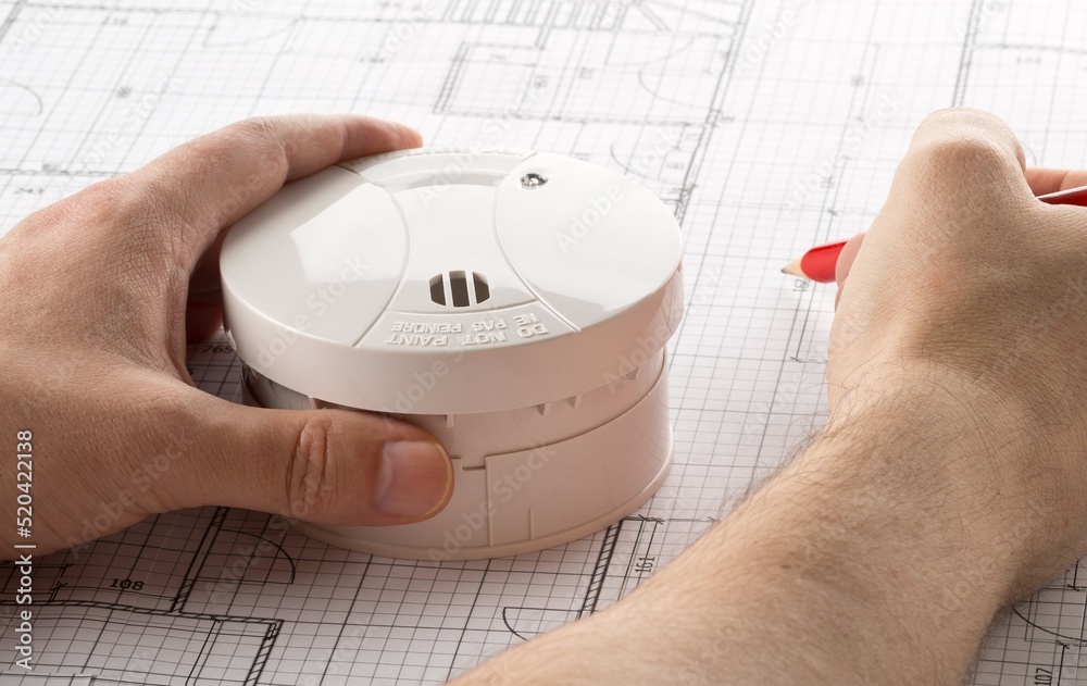 Planing for smoke detector or fire alarm sensor on white architectural ...