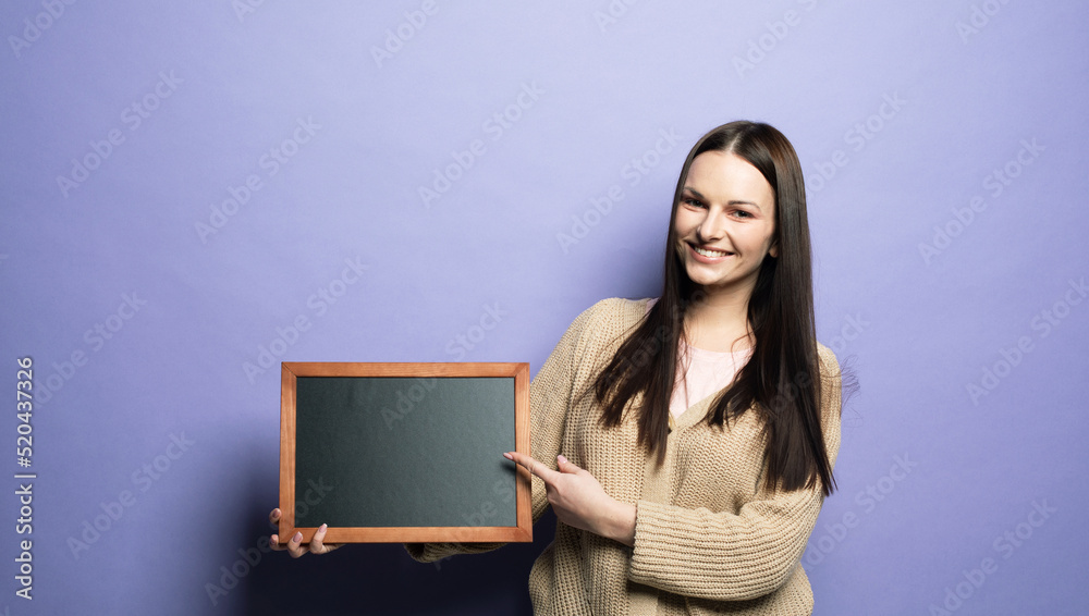 Young smiling student woman holding a chalkboard Stock Photo | Adobe Stock Young smiling student woman holding a chalkboard Stock Photo | Adobe Stock
