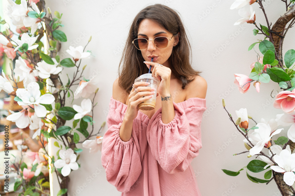 Young beautiful smiling woman in trendy summer pink dress. woman posing ...